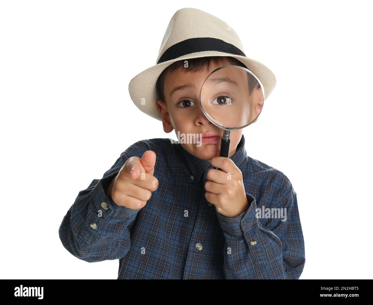 Little boy with magnifying glass playing detective on white background ...
