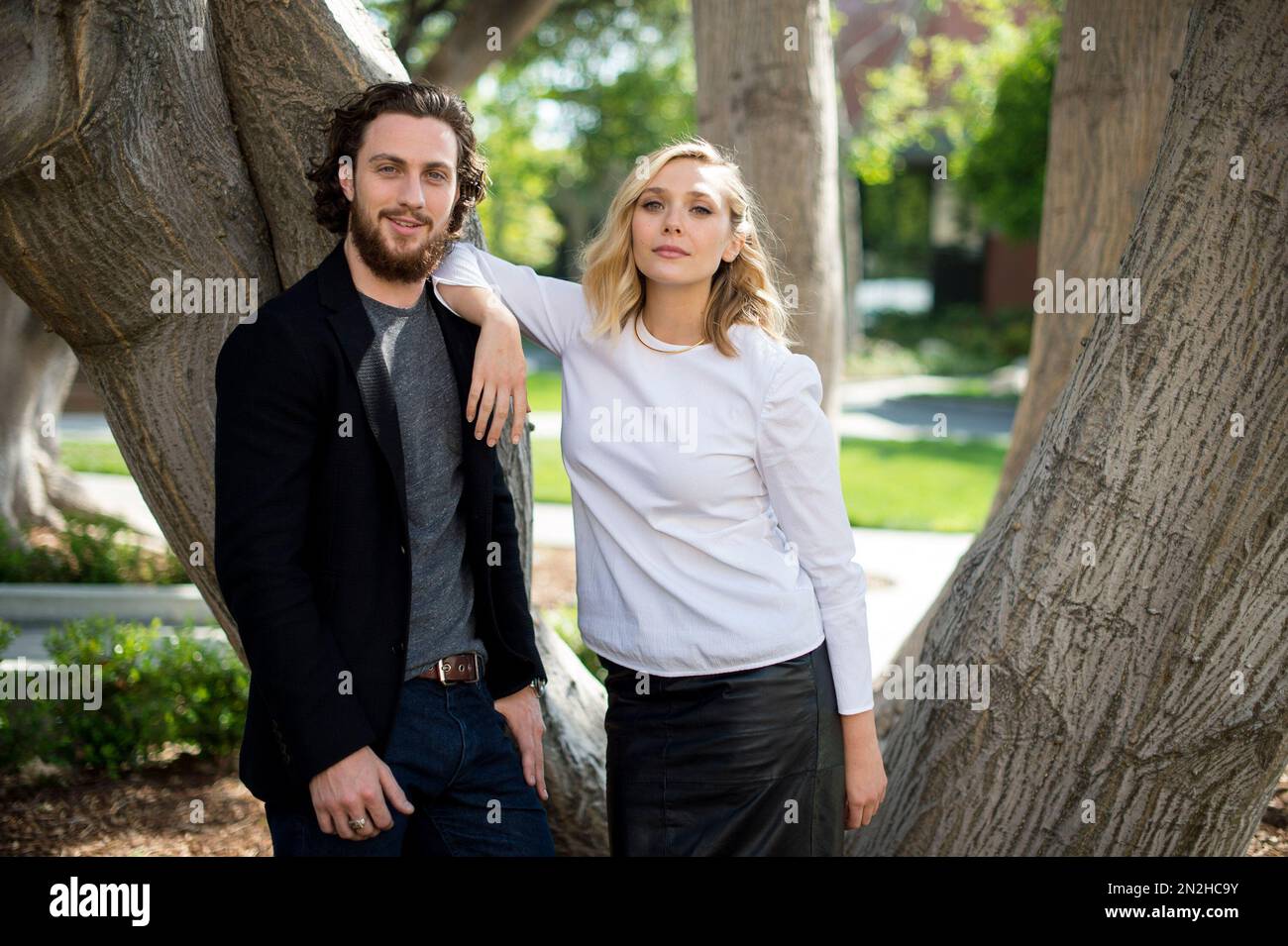 Elizabeth Olsen, left, and Aaron Taylor-Johnson pose during a portrait ...