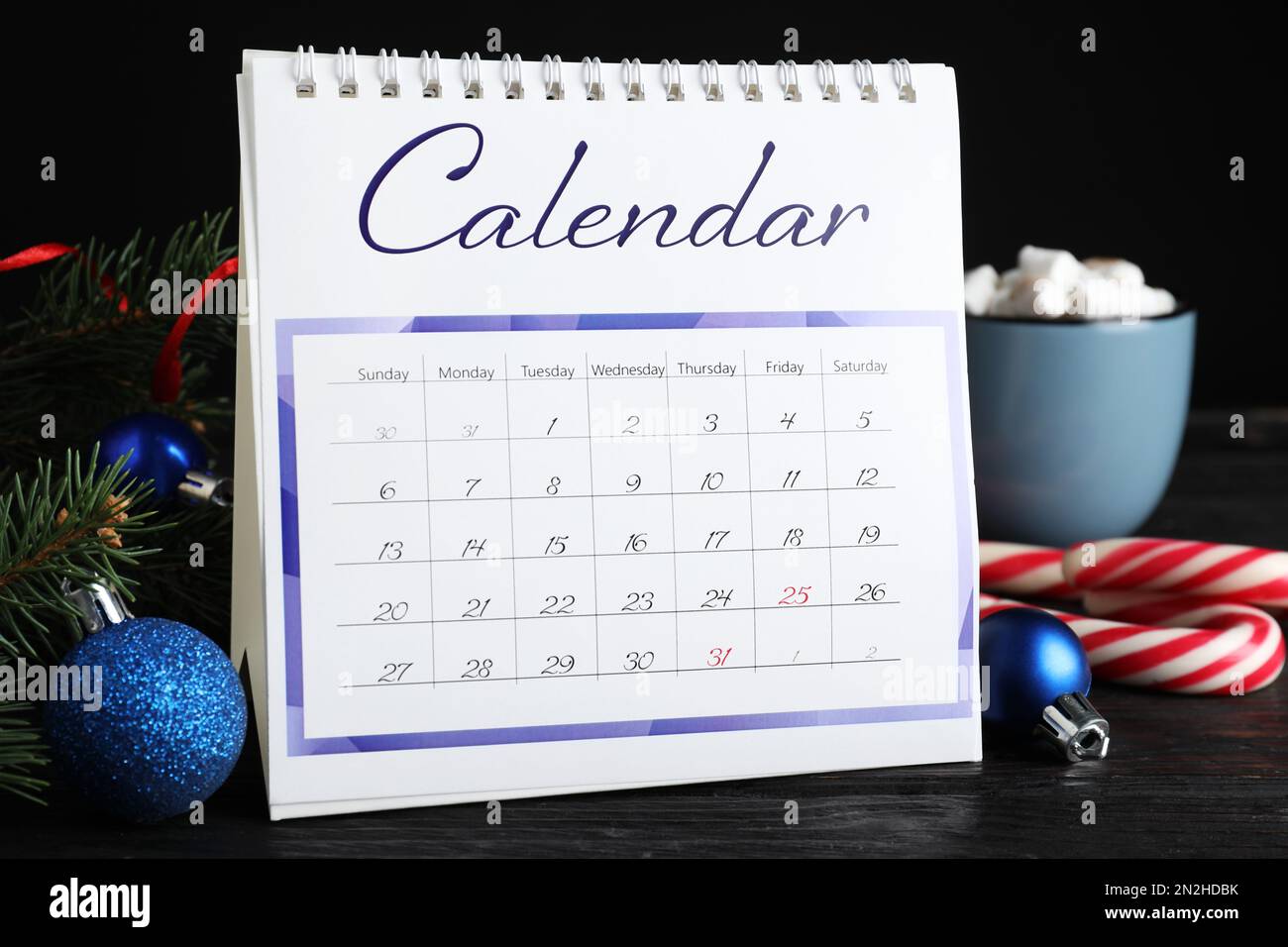 Flip calendar and Christmas decor on black wooden table. Holiday ...