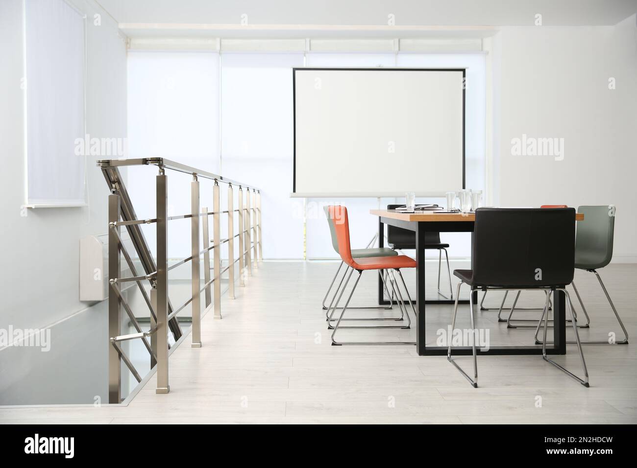 Modern meeting room interior with large table and projection screen ...