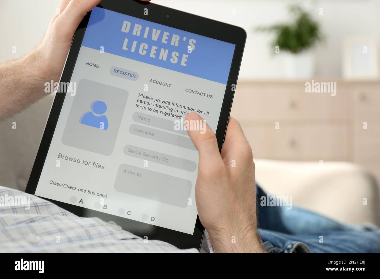 Man using tablet to fill driver's license application form at home, closeup Stock Photo - Alamy