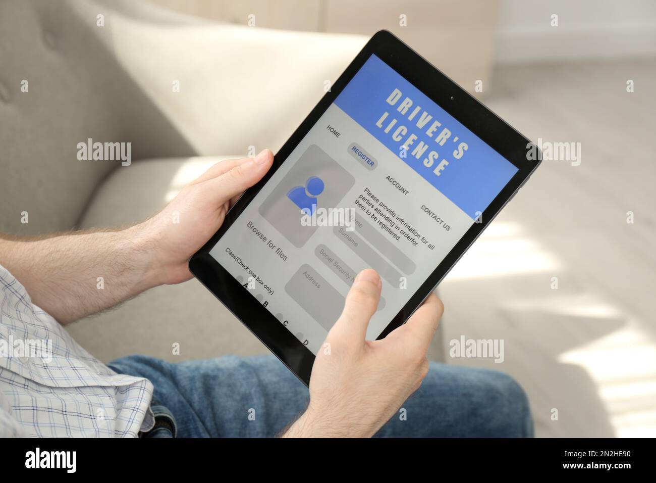 Man holding tablet with driver's license application form at home, closeup Stock Photo - Alamy