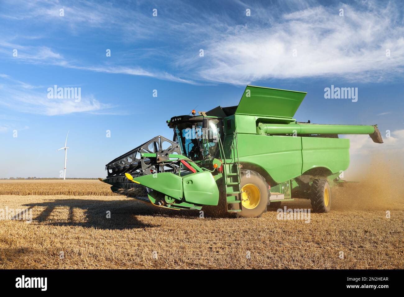 Modern combine harvester working in agricultural field Stock Photo - Alamy