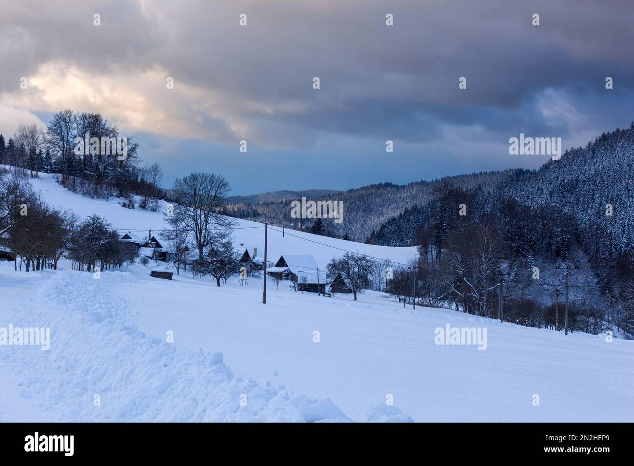 The middle mountain of Beskydy is under the snow. The sun illuminates ...
