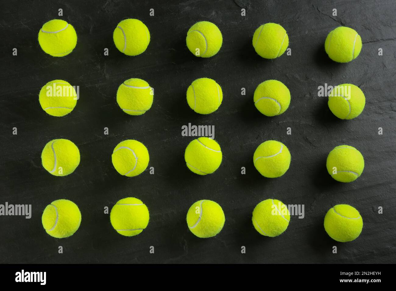 Tennis balls on black background, flat lay. Sports equipment Stock ...
