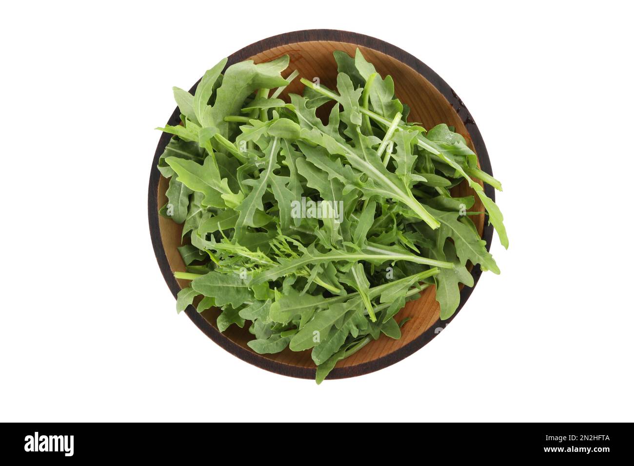 Delicious fresh arugula in wooden bowl isolated on white, top view ...
