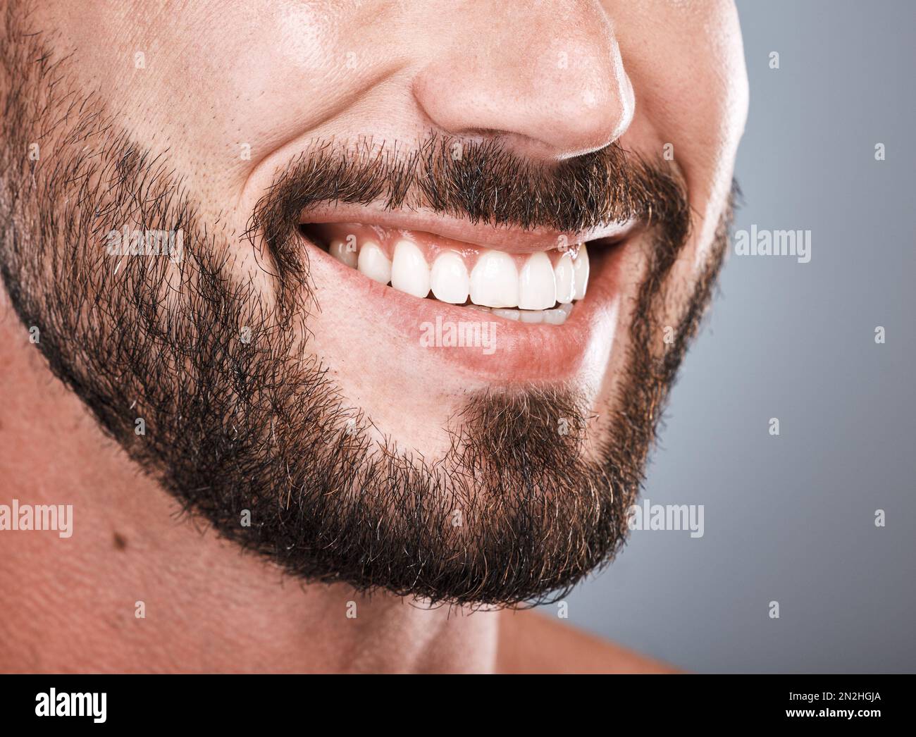 Smile, dental health and mouth of a man with teeth isolated on grey ...