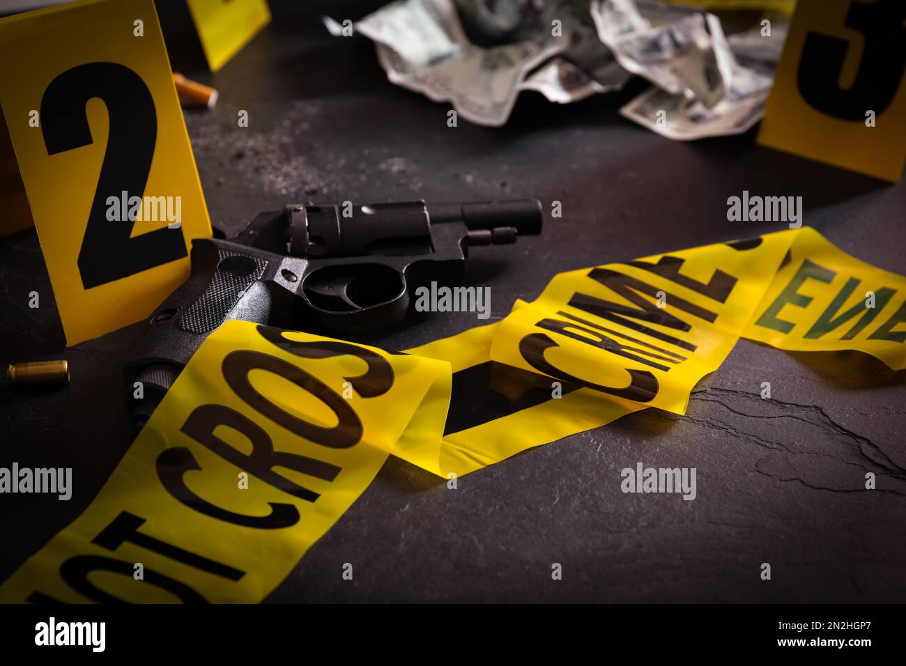 Composition with gun on black slate table. Crime scene Stock Photo - Alamy
