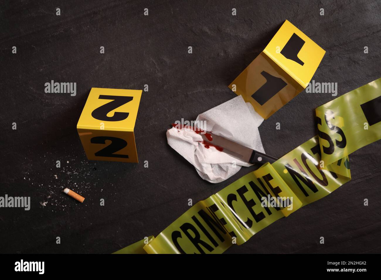 Flat lay composition with evidences and crime scene markers on black ...