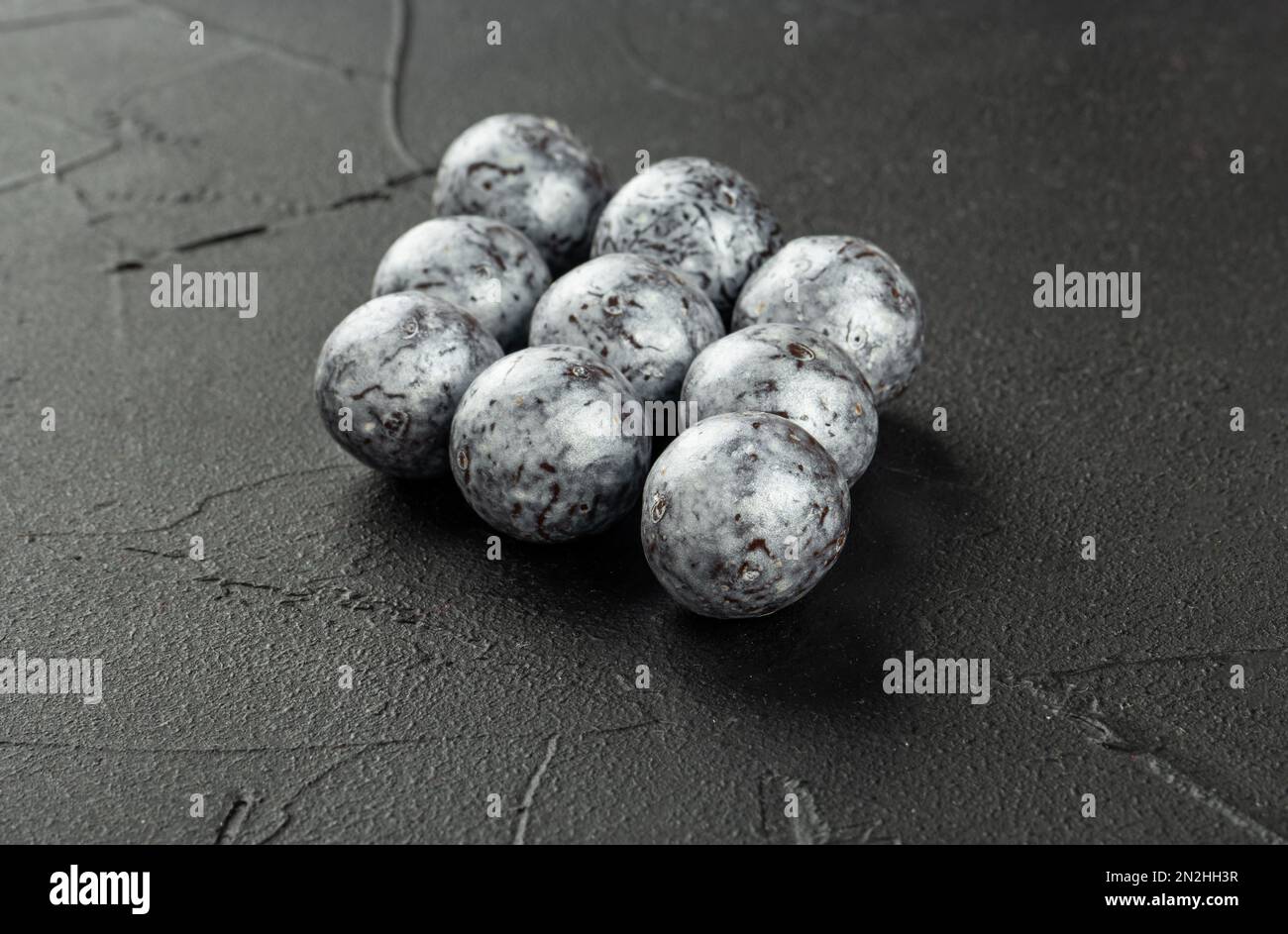 Silver candies hazelnuts in chocolate in the form of a rhombus on a ...