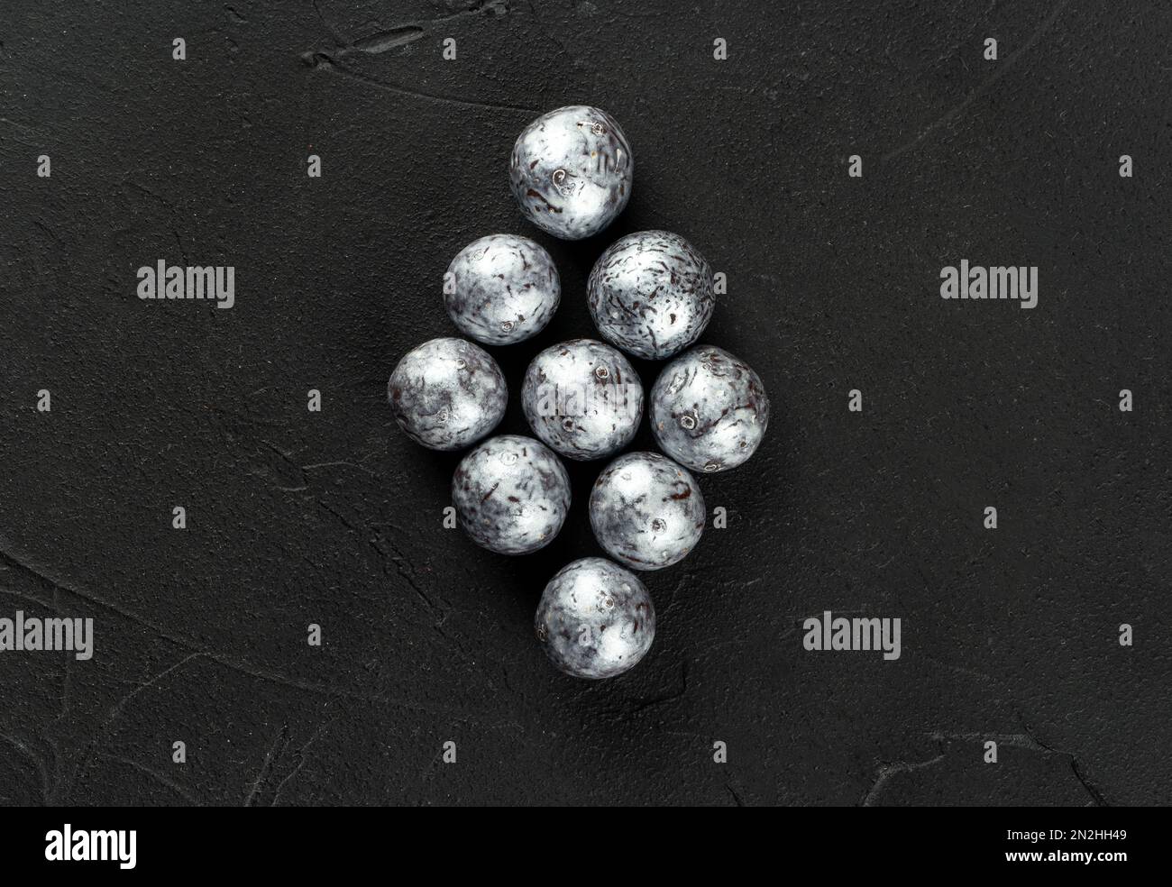 Silver candies hazelnuts in chocolate in the form of a rhombus on a ...