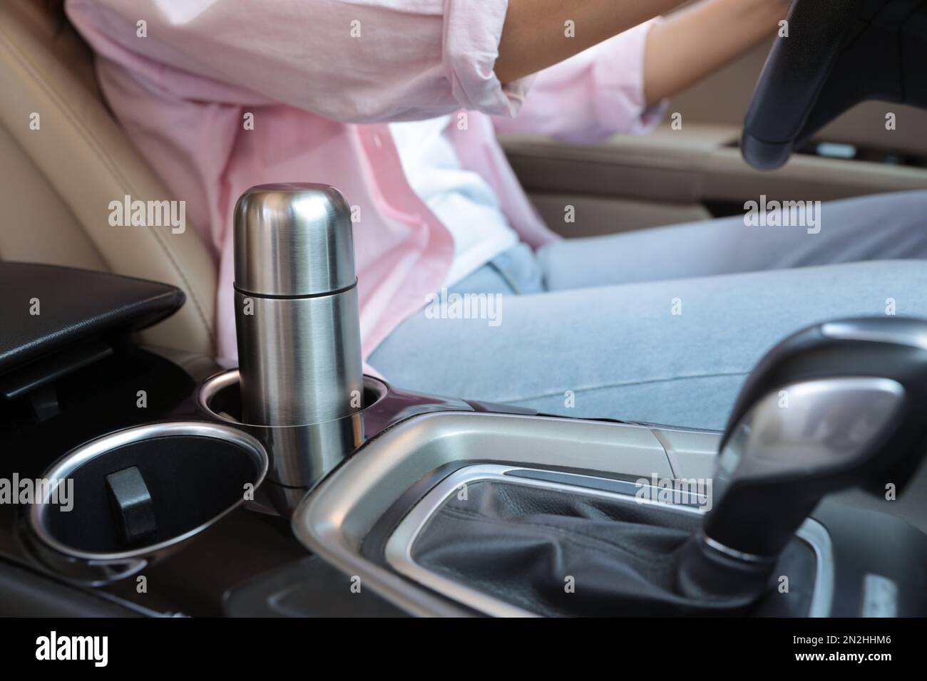 Silver thermos in holder inside of car Stock Photo - Alamy