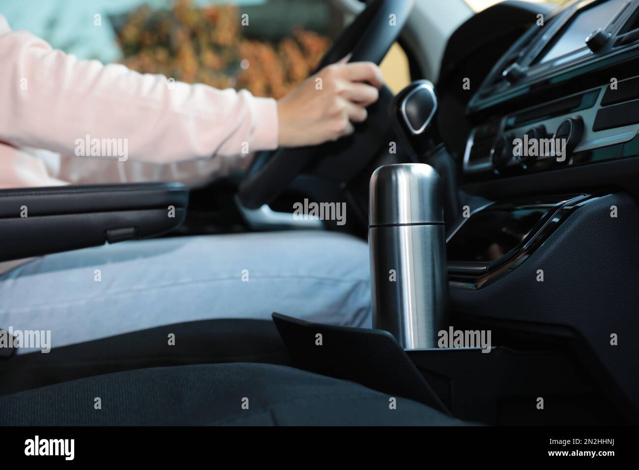 Silver thermos in holder inside of car Stock Photo - Alamy