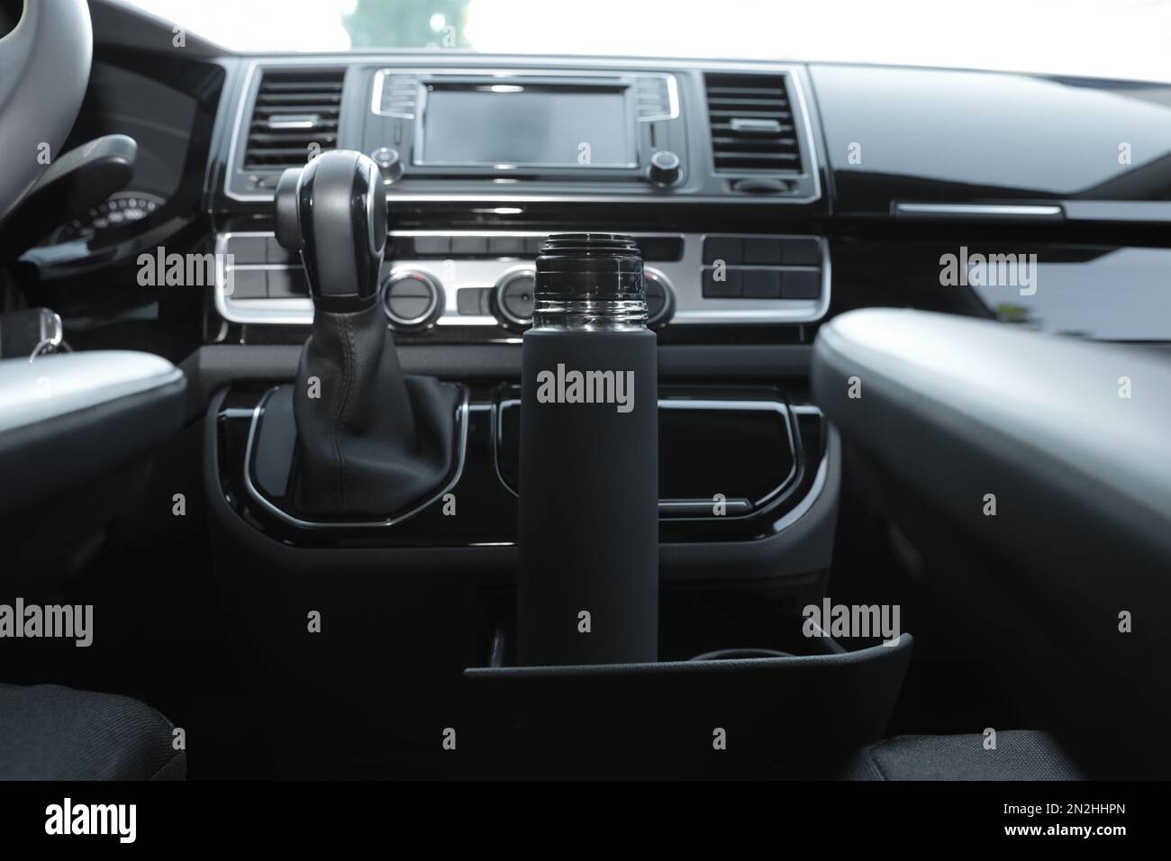 Black thermos in holder inside of car Stock Photo - Alamy