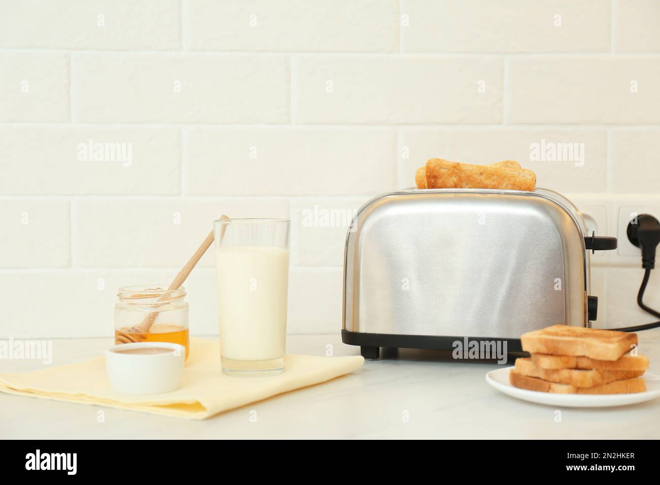 Modern toaster and tasty breakfast on counter in kitchen Stock Photo ...