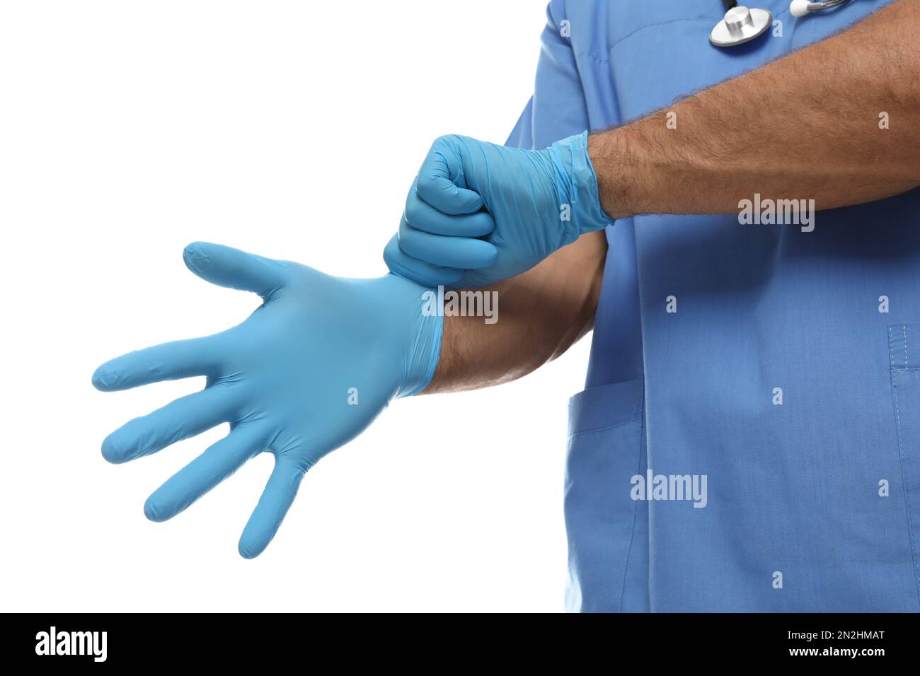 Doctor putting on medical gloves against white background, closeup ...