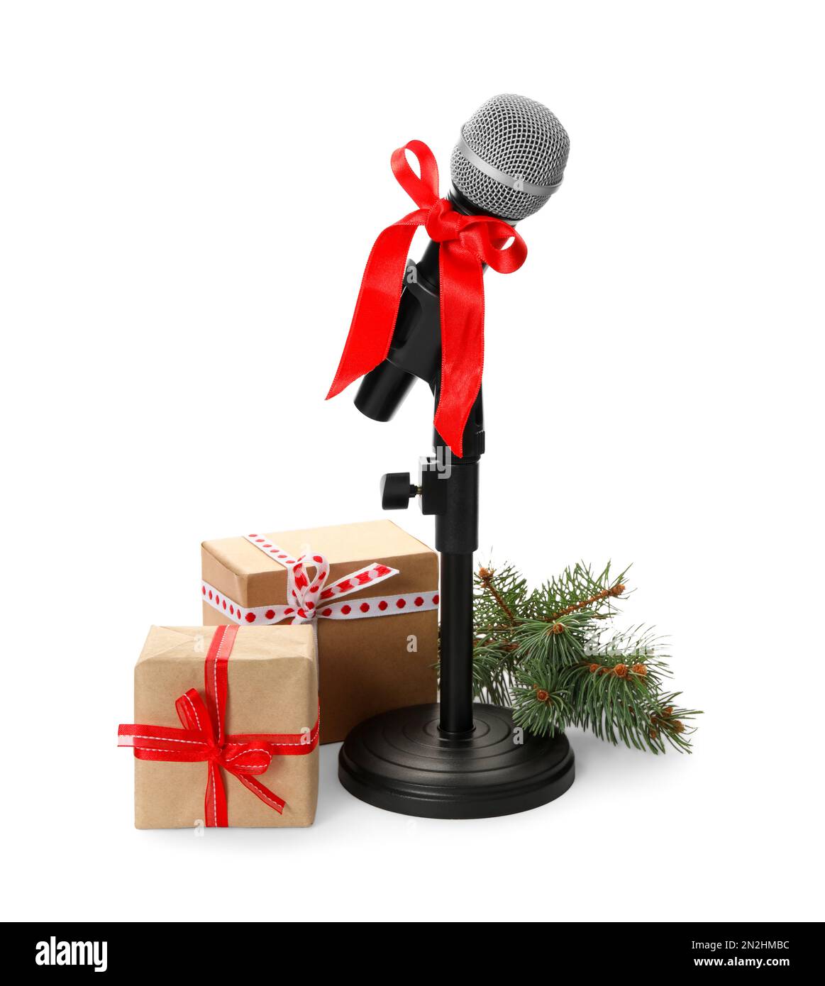 Microphone with red bow, gift boxes and festive decor on white ...