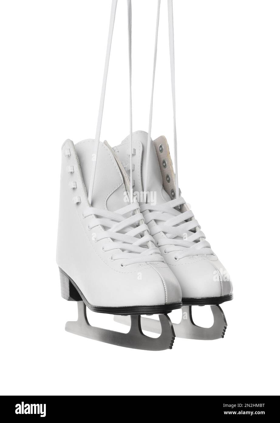 Pair of figure ice skates hanging on white background Stock Photo - Alamy