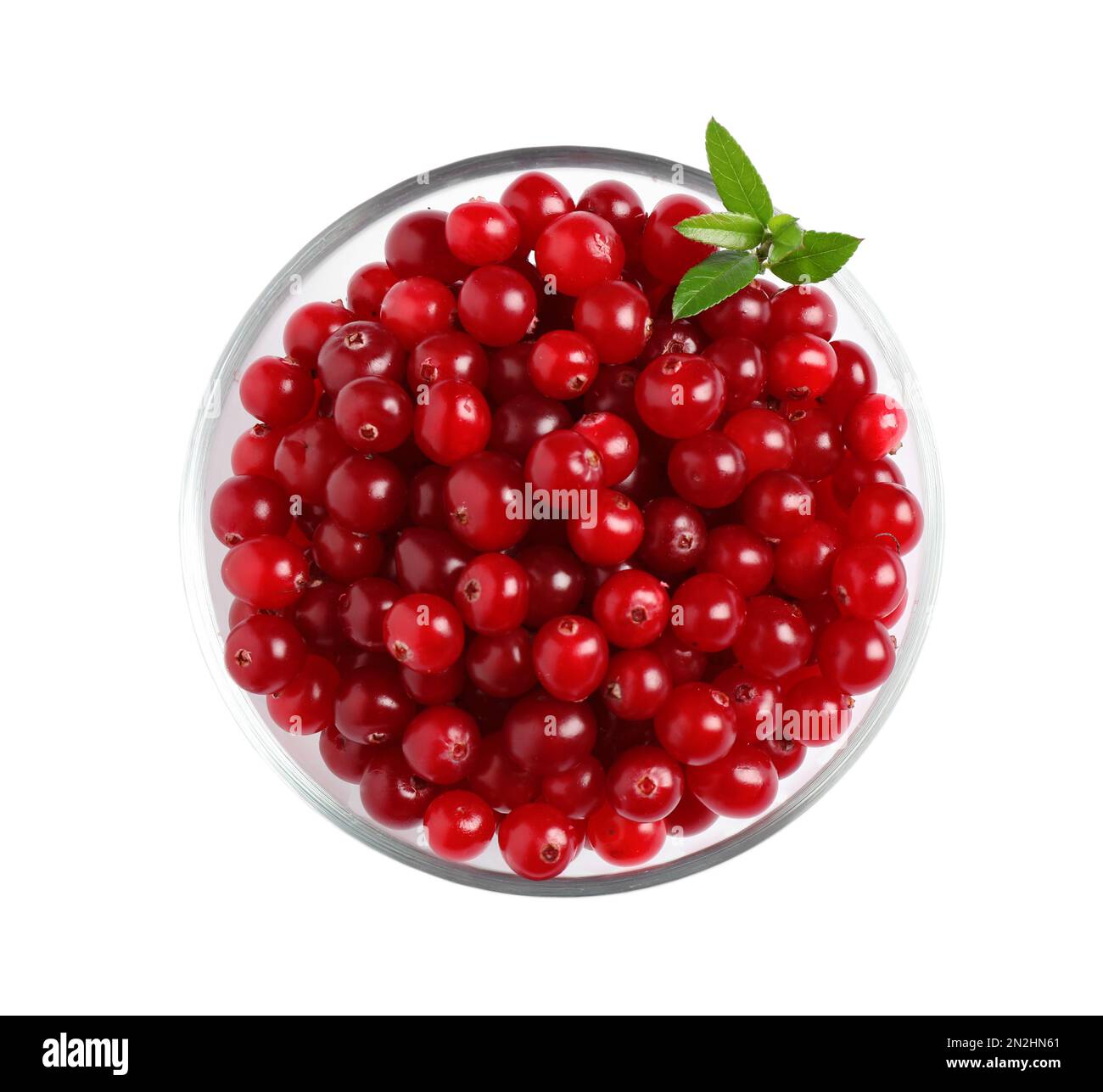 Fresh ripe cranberries with leaves in bowl isolated on white, top view ...