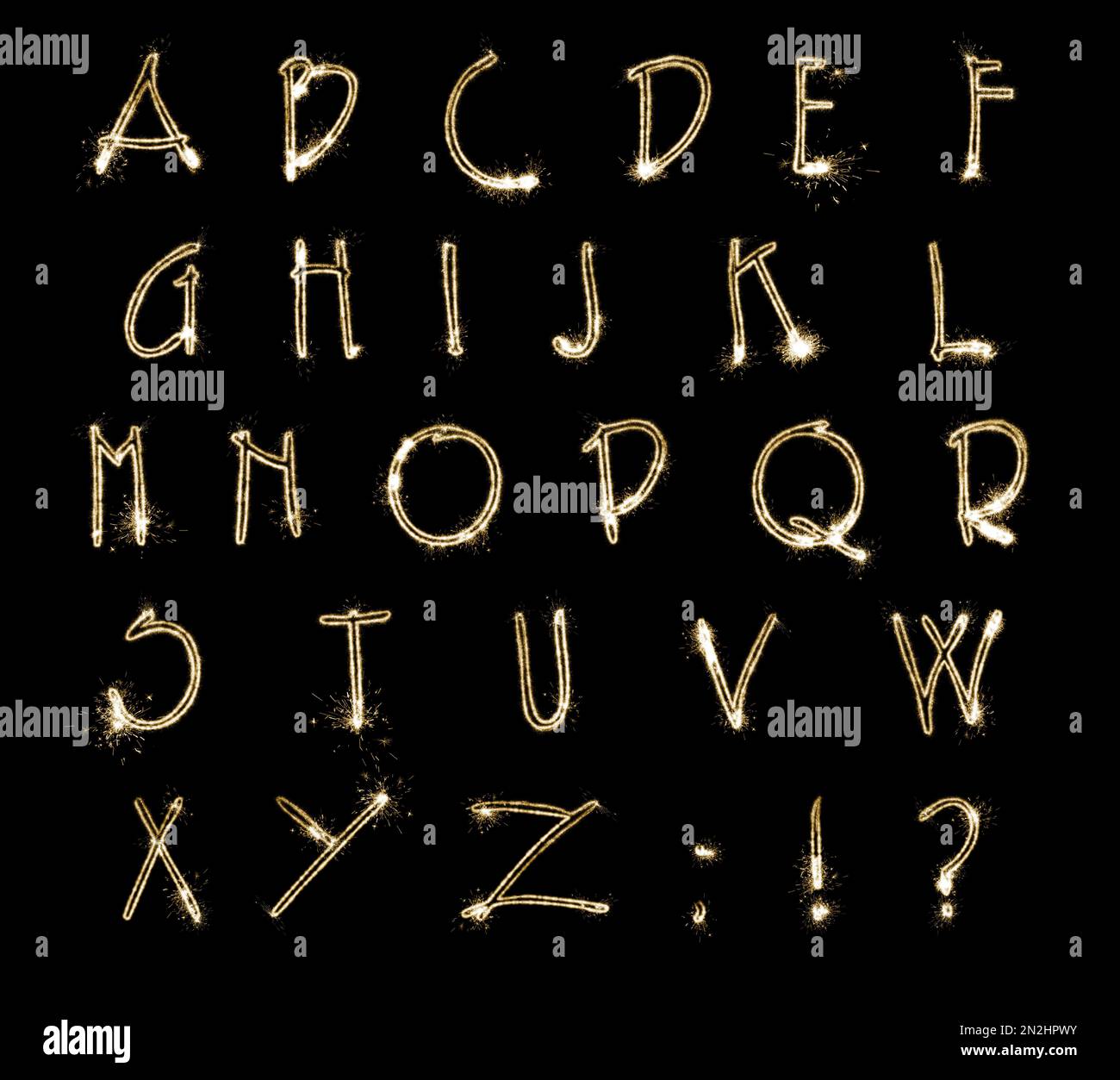 Set with letters made of sparkler on black background Stock Photo - Alamy