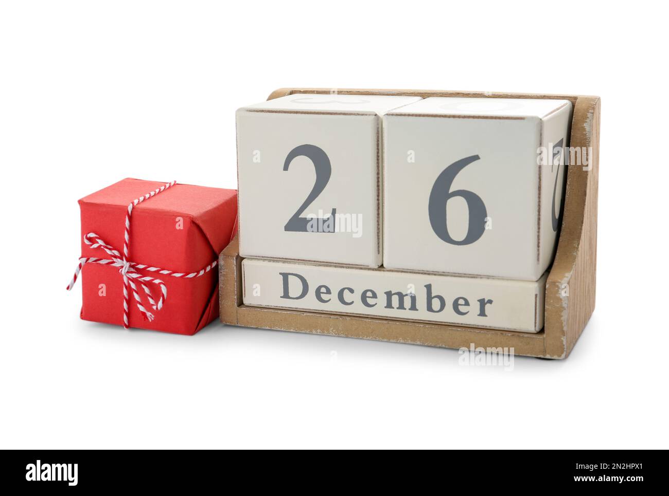 Wooden block calendar with date 26th of December near gift on white ...