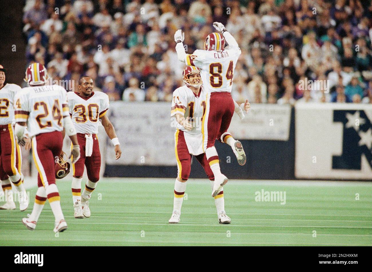 Washington Redskins Gary Clark (84) jumps into the arms of Mark Rypien ...