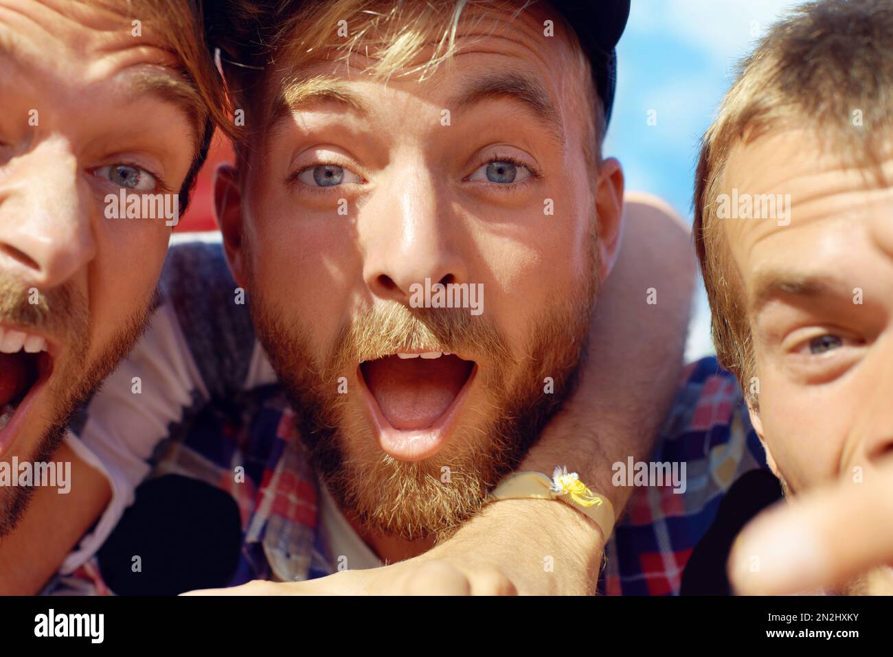 Jolly good fellows. three happy guys enjoying themselves at an outdoor ...