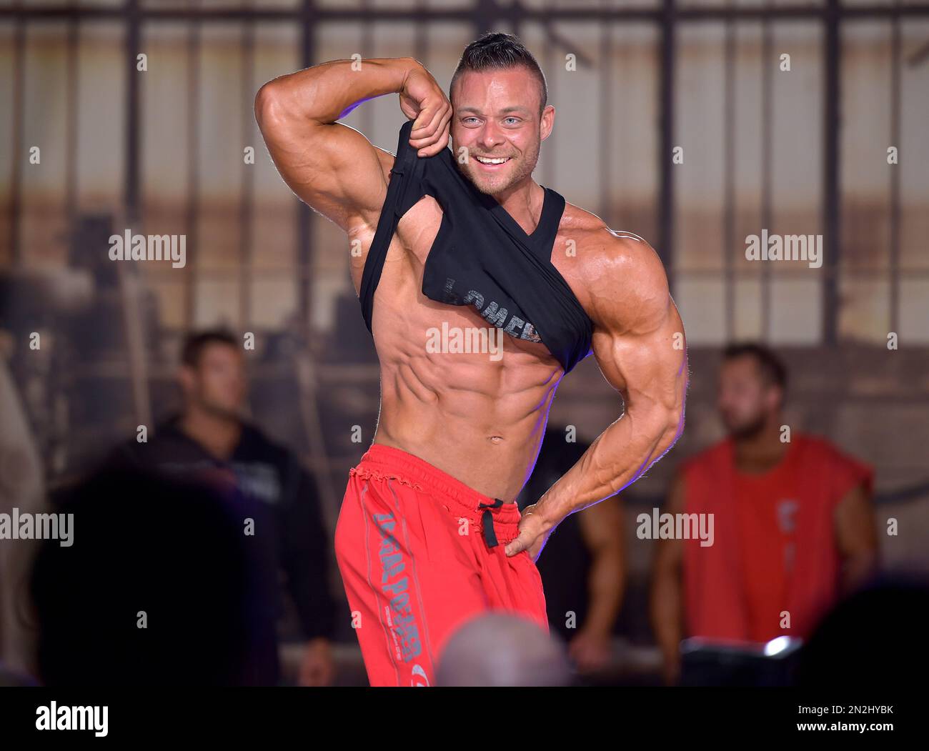 A bodybuilder poses on stage at the FIBO Power, a bodybuilding fair in ...