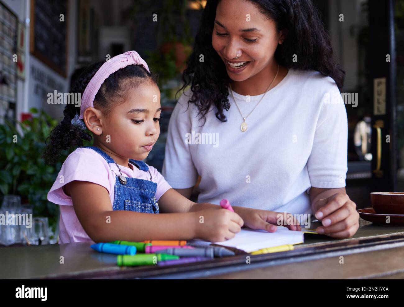 Bonding, drawing and mother and child at a restaurant with art ...