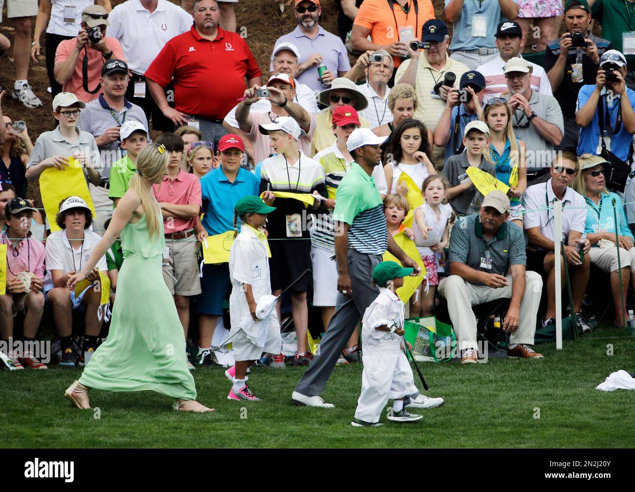 Lindsey Vonn walks with Tiger Woods and his children Sam and Charlie ...