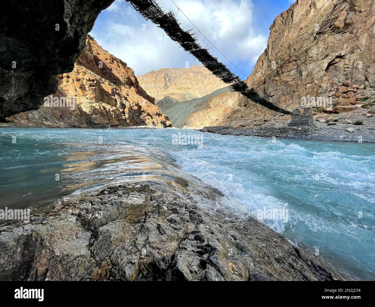 A flowing river surrounded by rocky Ladakh & Zanskar mountains Stock ...