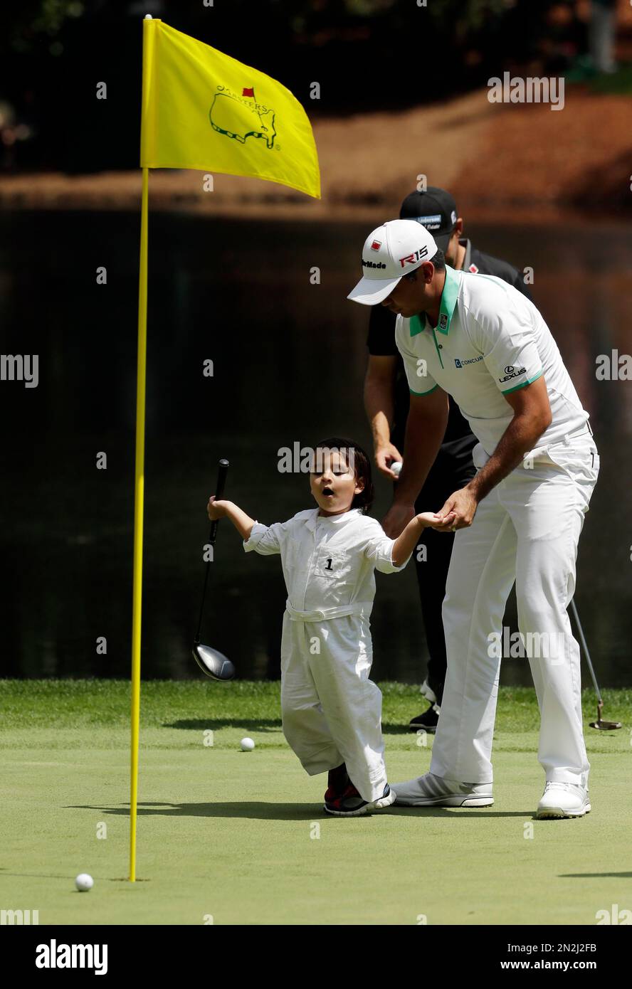 Jason Day, of Australia's son Dash reacts after putting on the ninth ...