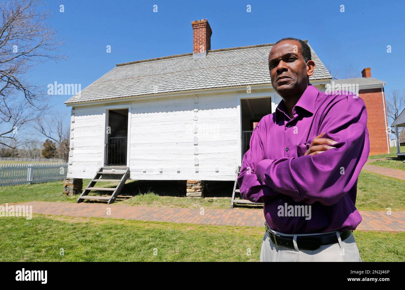 Rev. Alfred L. Jones III poses in front of the reconstructed slave ...