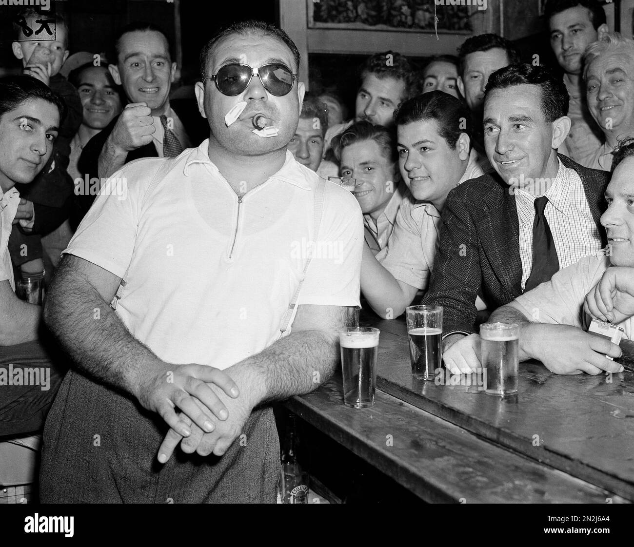 With bandages on his face and dark sunglasses to cover his battered ...