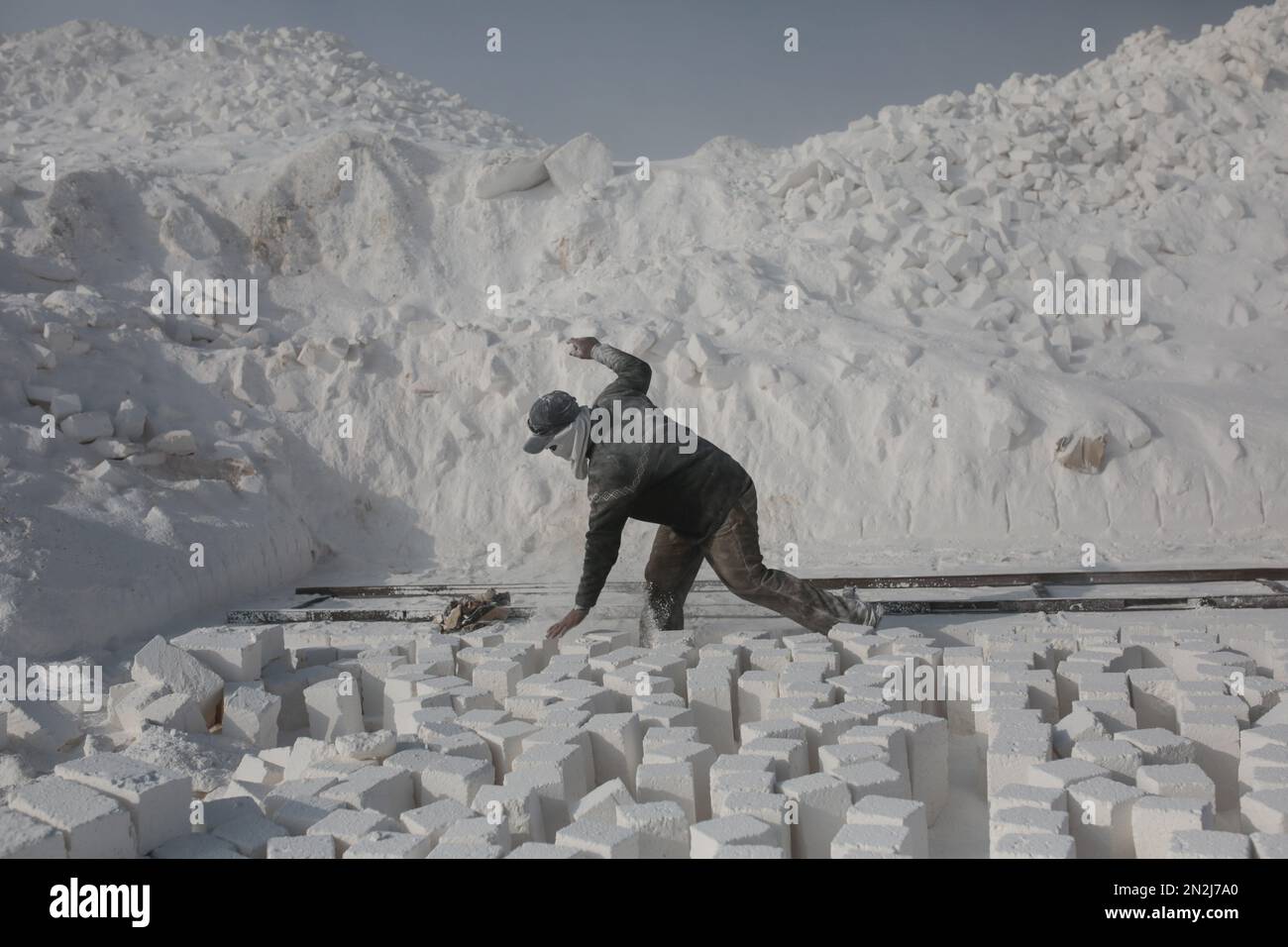 In this Wednesday, March 18, 2015 photo, a quarry workers wearing a ...