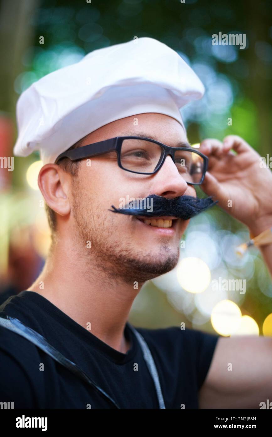 Sporting a french moustache. A young man dressed in a french costume ...
