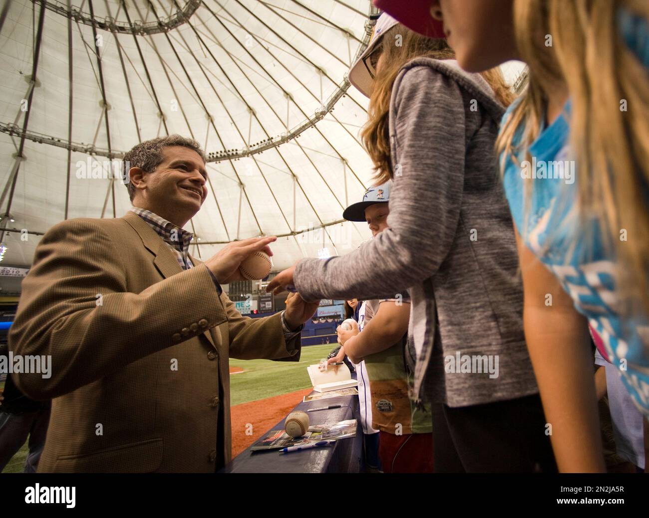 Tampa Bay Rays principal owner Stuart Sternberg signs baseballs as he ...