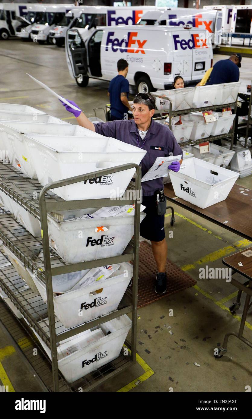 In this July 9, 2014 photo, Diana Chalfant sorts packages at the FedEx ...