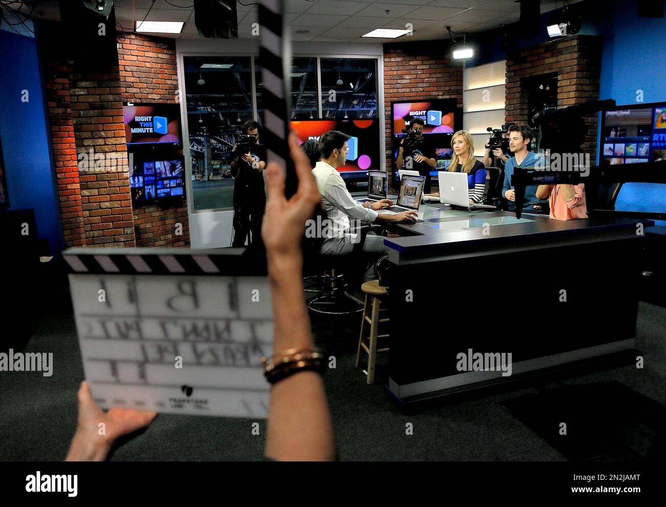 In this March 31, 2015 photo, background from left, Nick Calderone ...