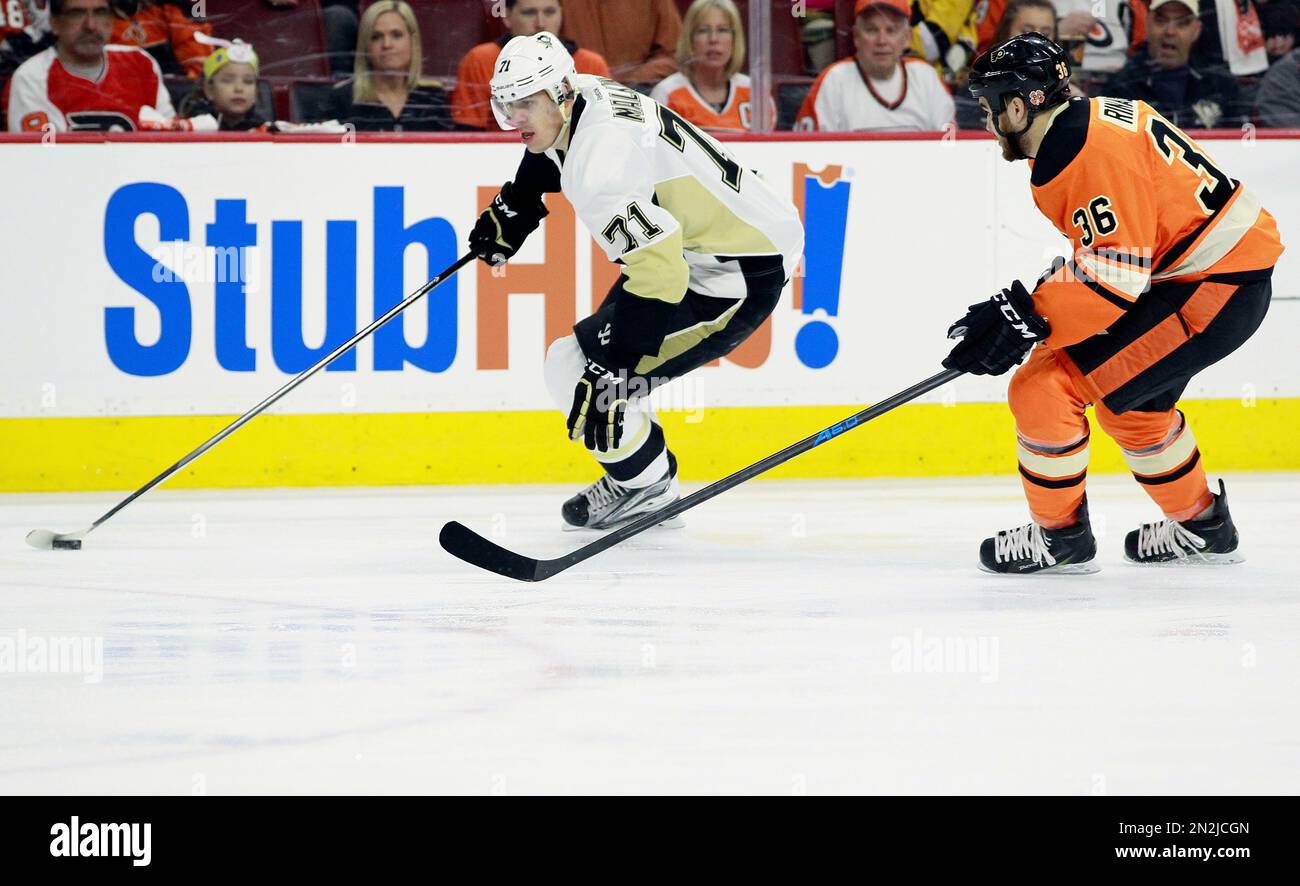 Pittsburgh Penguins' Evgeni Malkin, left, is trailed by Philadelphia ...