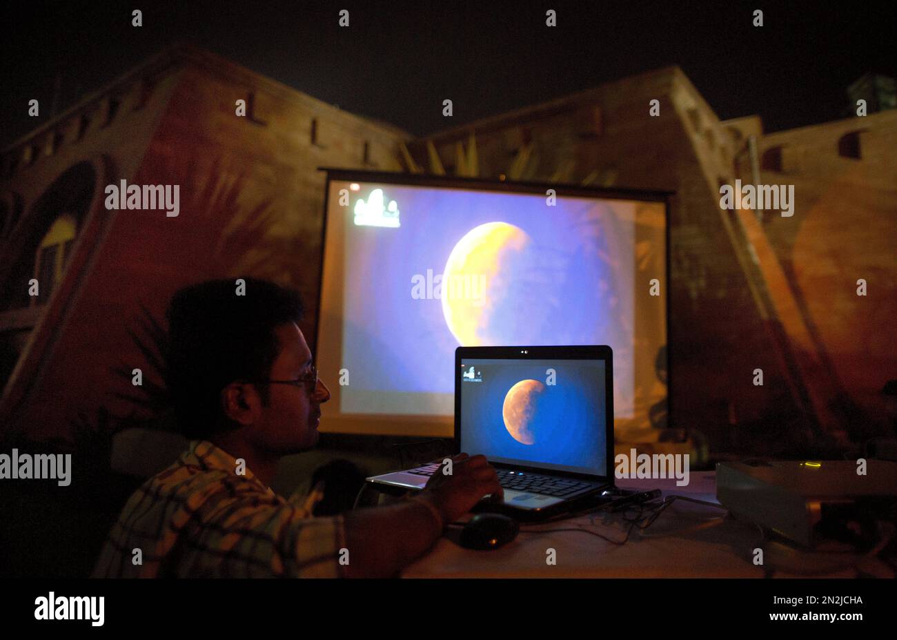 An employee of a planetarium displays on a projection screen a lunar ...