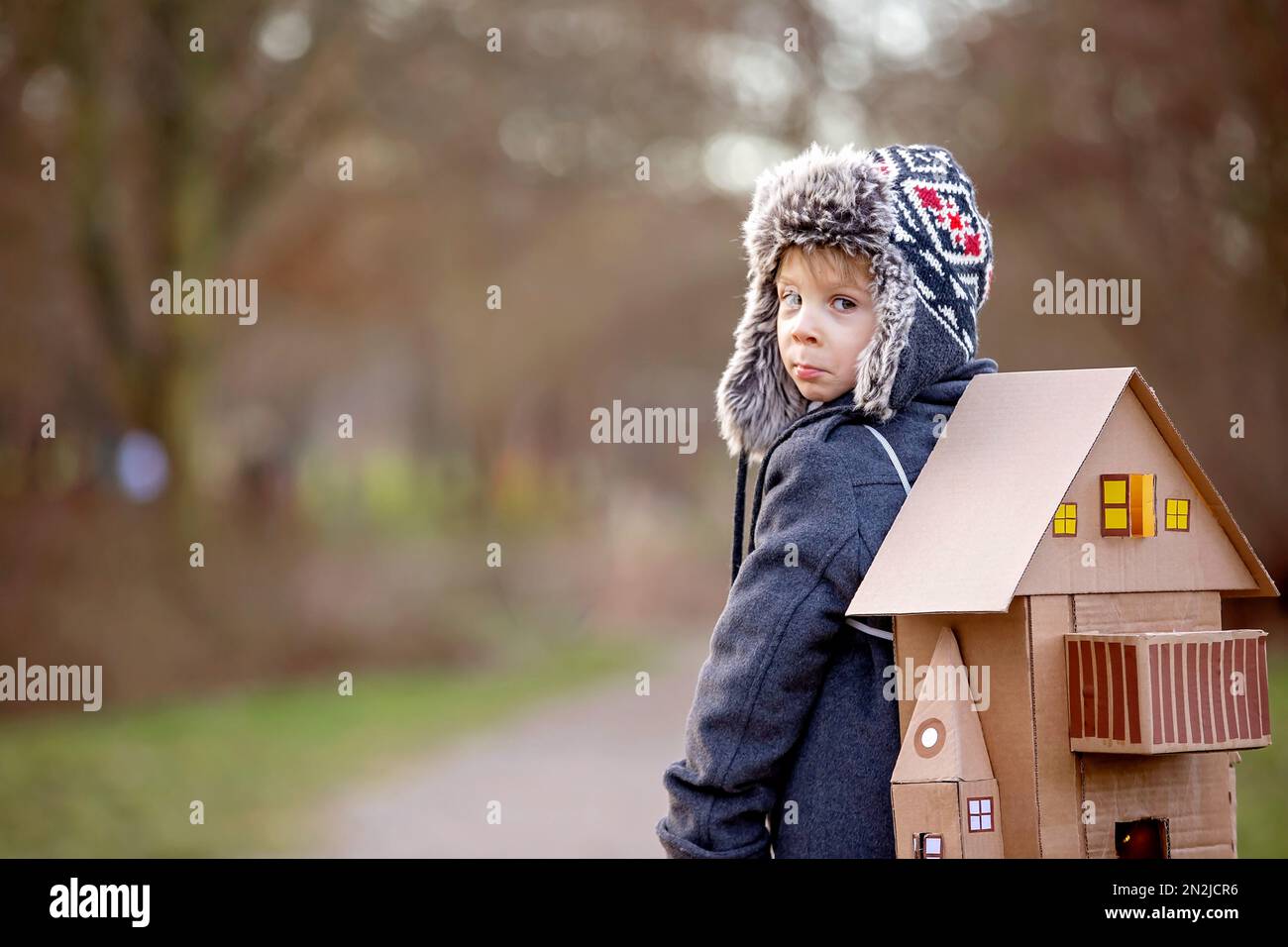 Little child, blond boy with pet dog, carying home on his back, kid ...