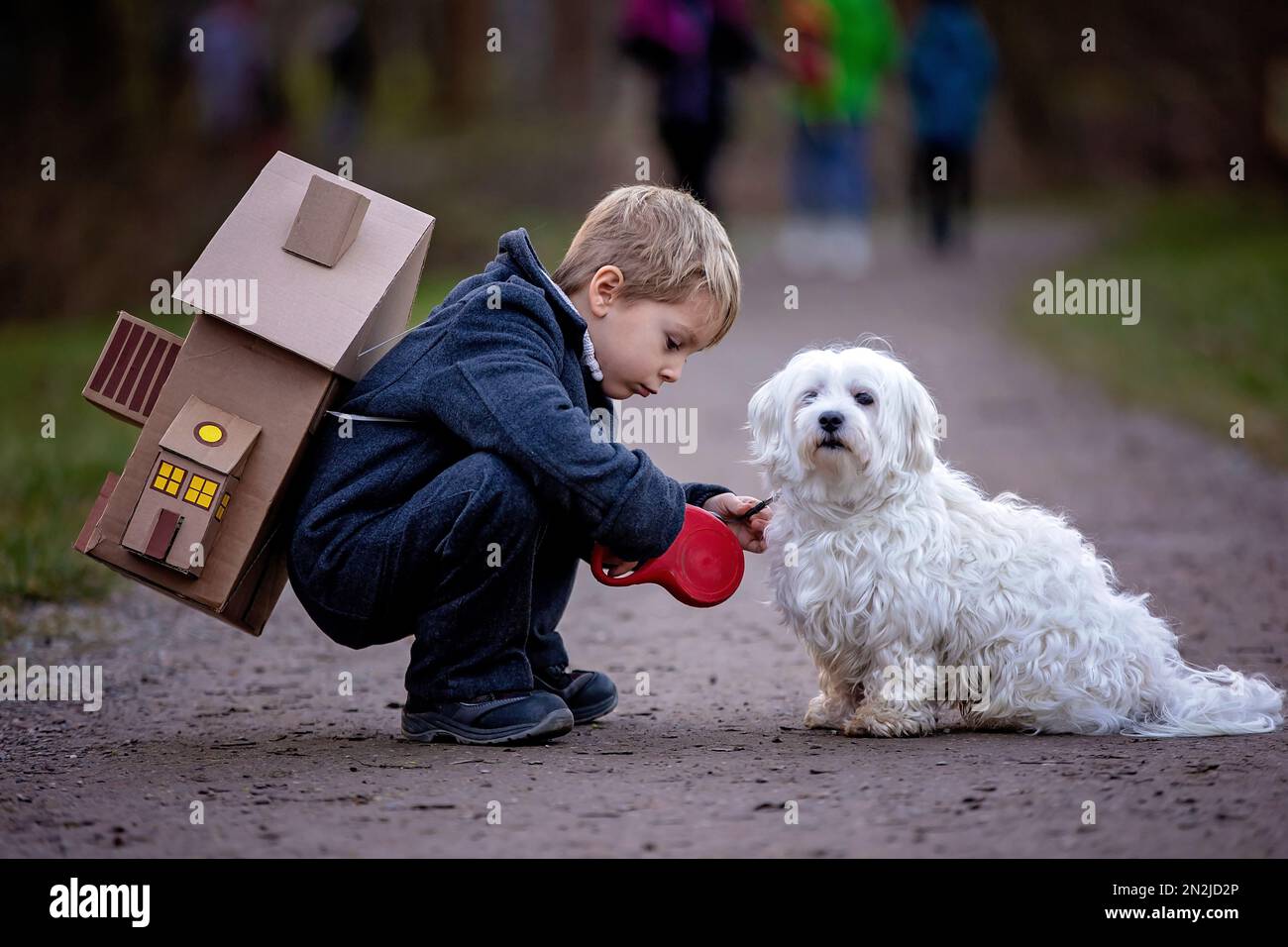 Little child, blond boy with pet dog, carying home on his back, kid ...