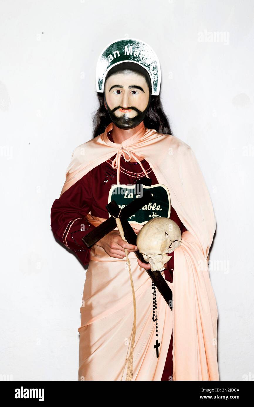 A penitent poses for a picture dressed with typical Apostle dress ...