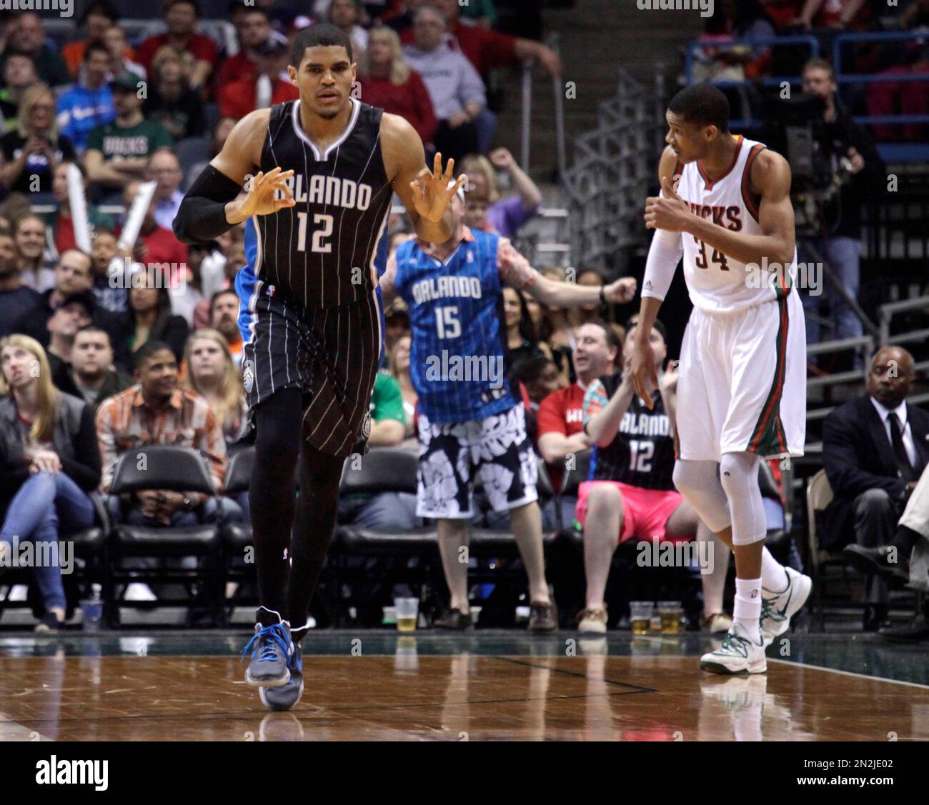Orlando Magic forward Tobias Harris, left, reacts after making a ...
