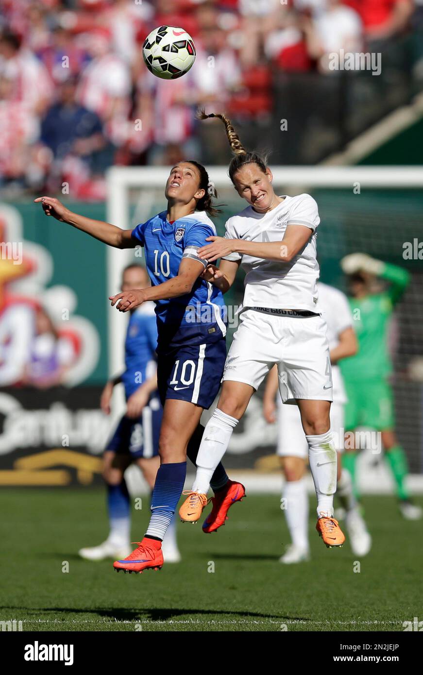 United States’ Carli Lloyd, left, and New Zealand’s Katie Duncan head ...