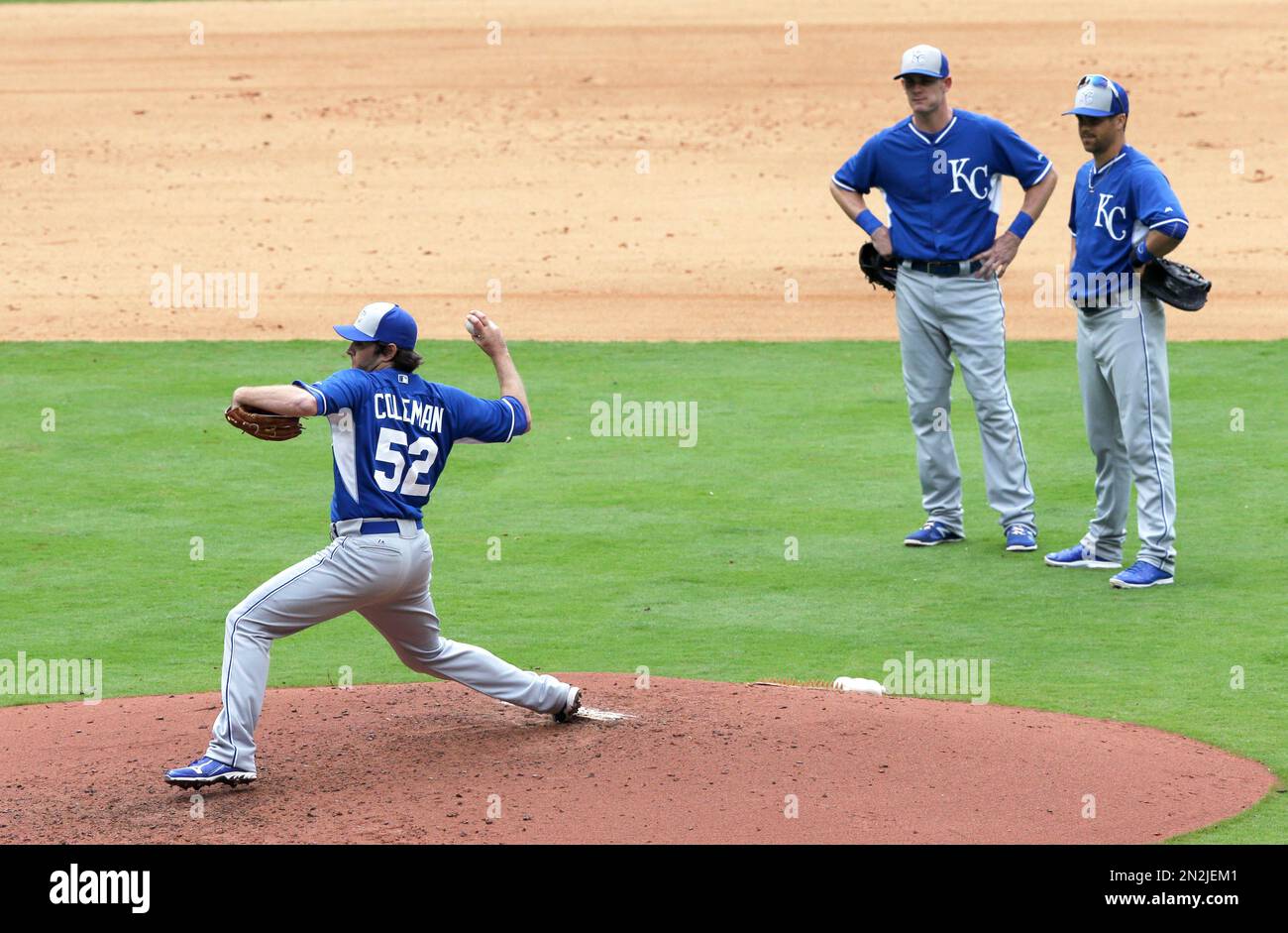 Kansas City Royals infielders Ryan Jackson, center, and Whit Merrifield ...