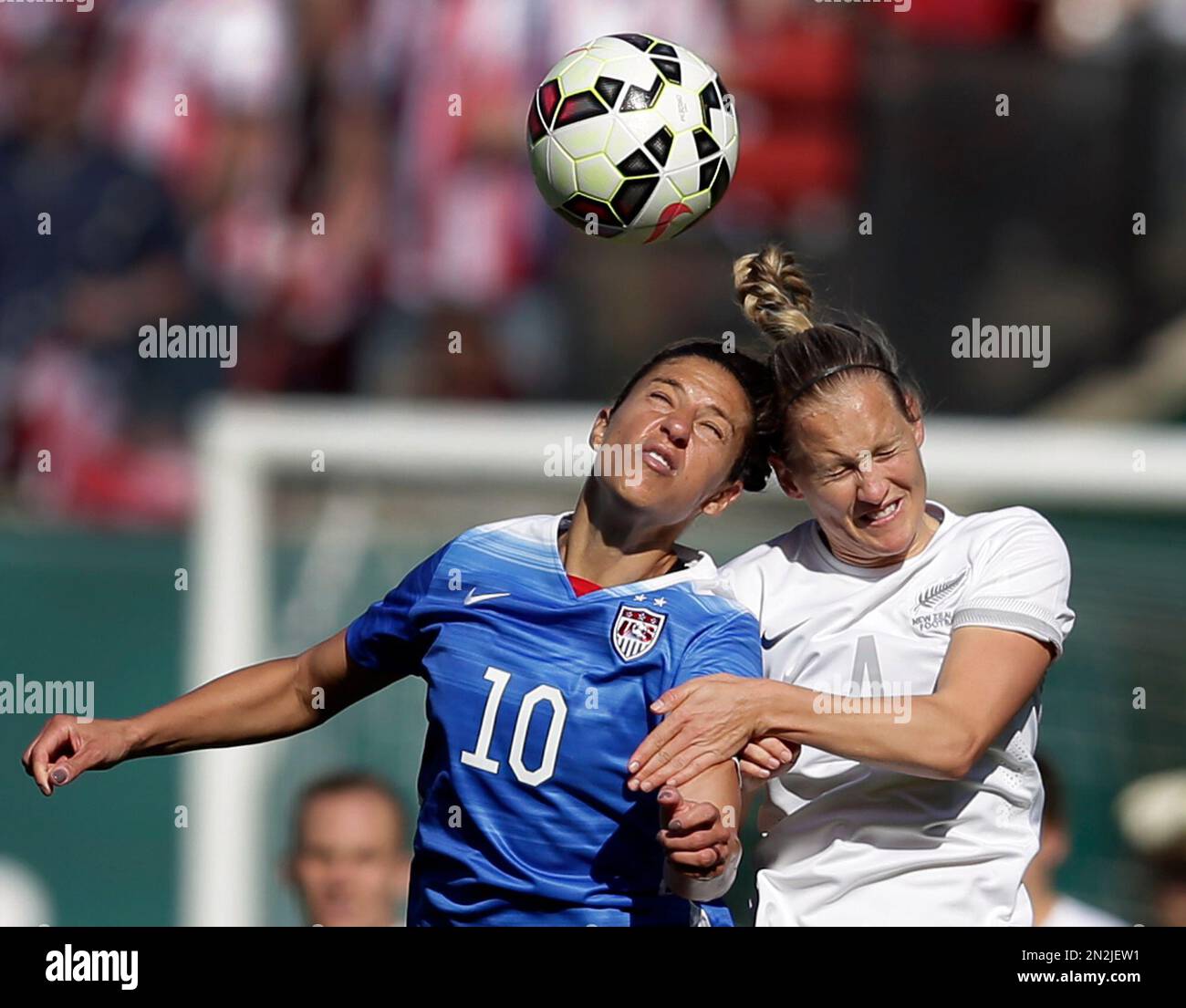 United States’ Carli Lloyd, left, and New Zealand’s Katie Duncan head ...