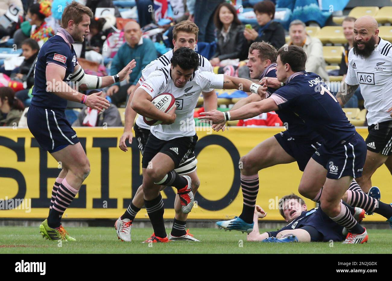 Sherwin Stowers of New Zealand, center, fends off Scotland's players ...