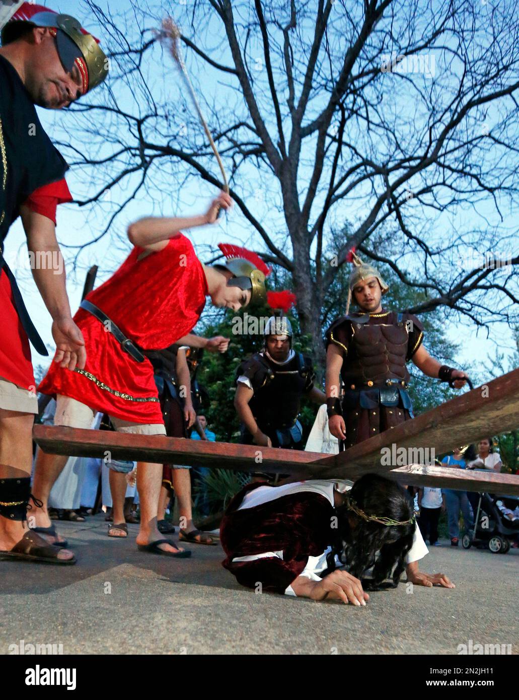 Victor Gomez, portraying Jesus Christ, falls and is beaten by the ...